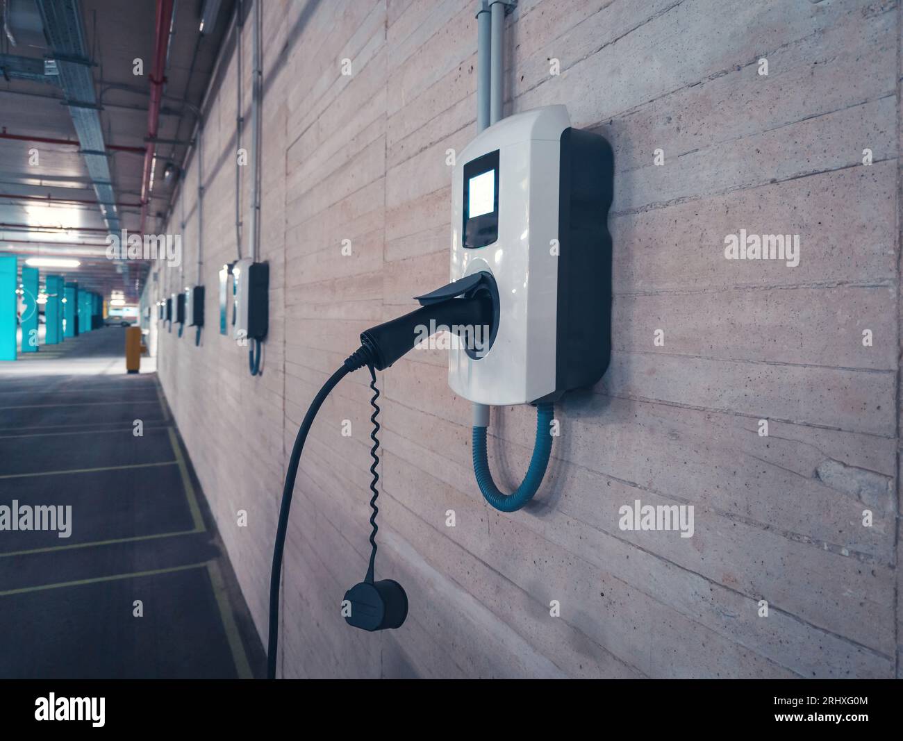 Cable connected to charging point for battery recharge at electric car ...