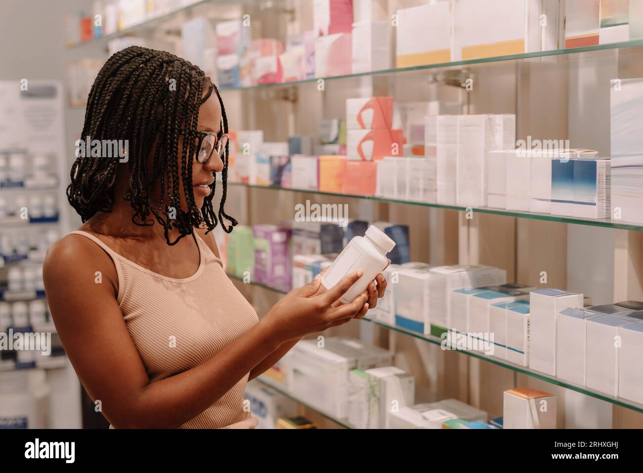 Woman reading a pill bottle label hi-res stock photography and images ...
