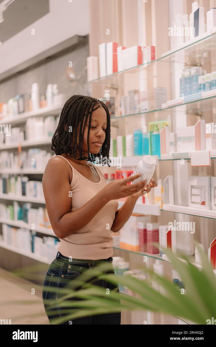 Woman reading a pill bottle label hi-res stock photography and images ...