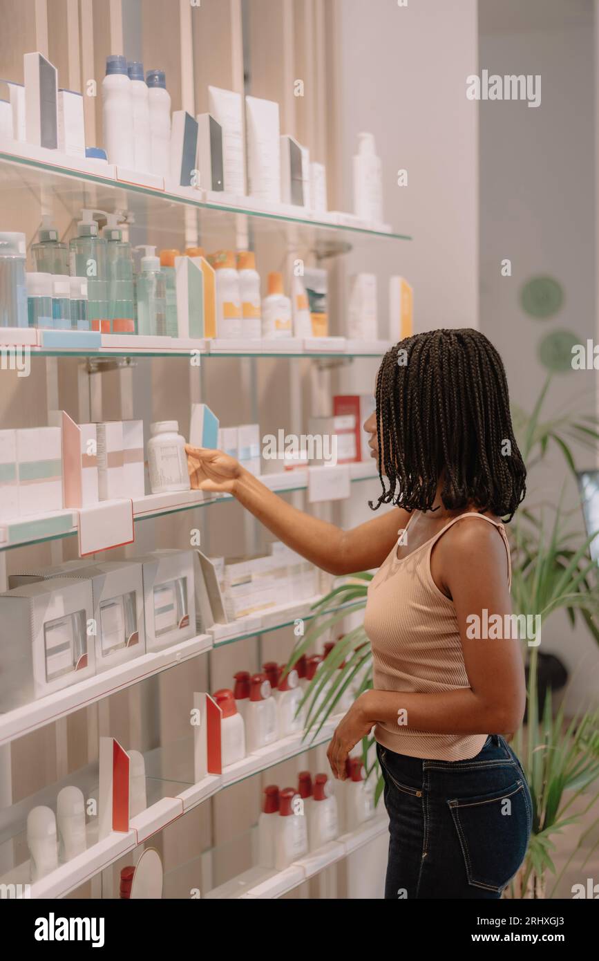 Woman reading a pill bottle label hi-res stock photography and images ...