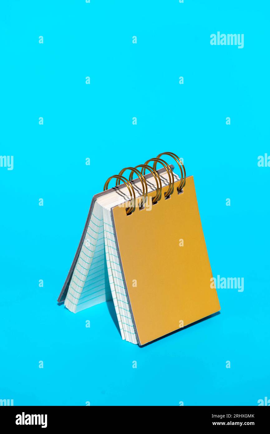 Top spiral bound yellow hardcovers parallel line papers notebook placed ...