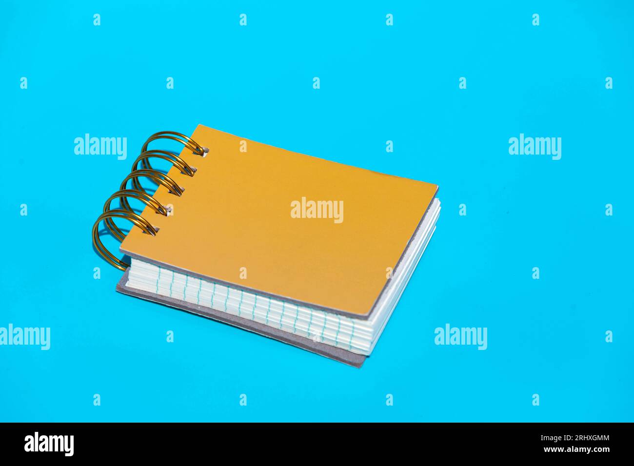 Top spiral bound yellow hardcovers parallel line papers notebook placed ...