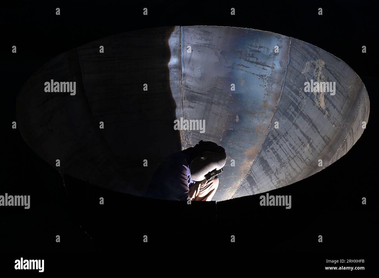 Prayagraj, India. 19th August 2023, A welder constructs a pontoon of ...
