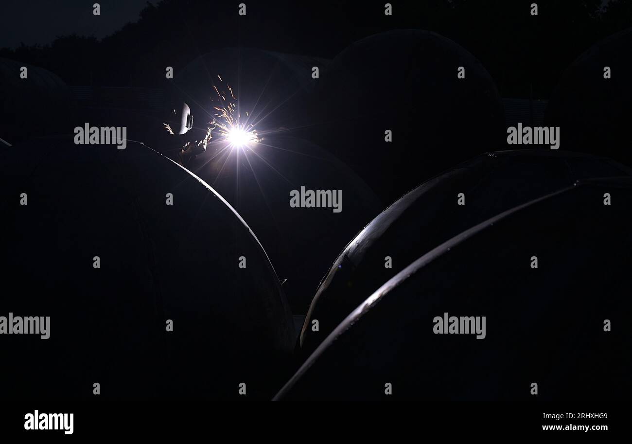 Prayagraj, India. 19th August 2023, A welder constructs a pontoon of ...