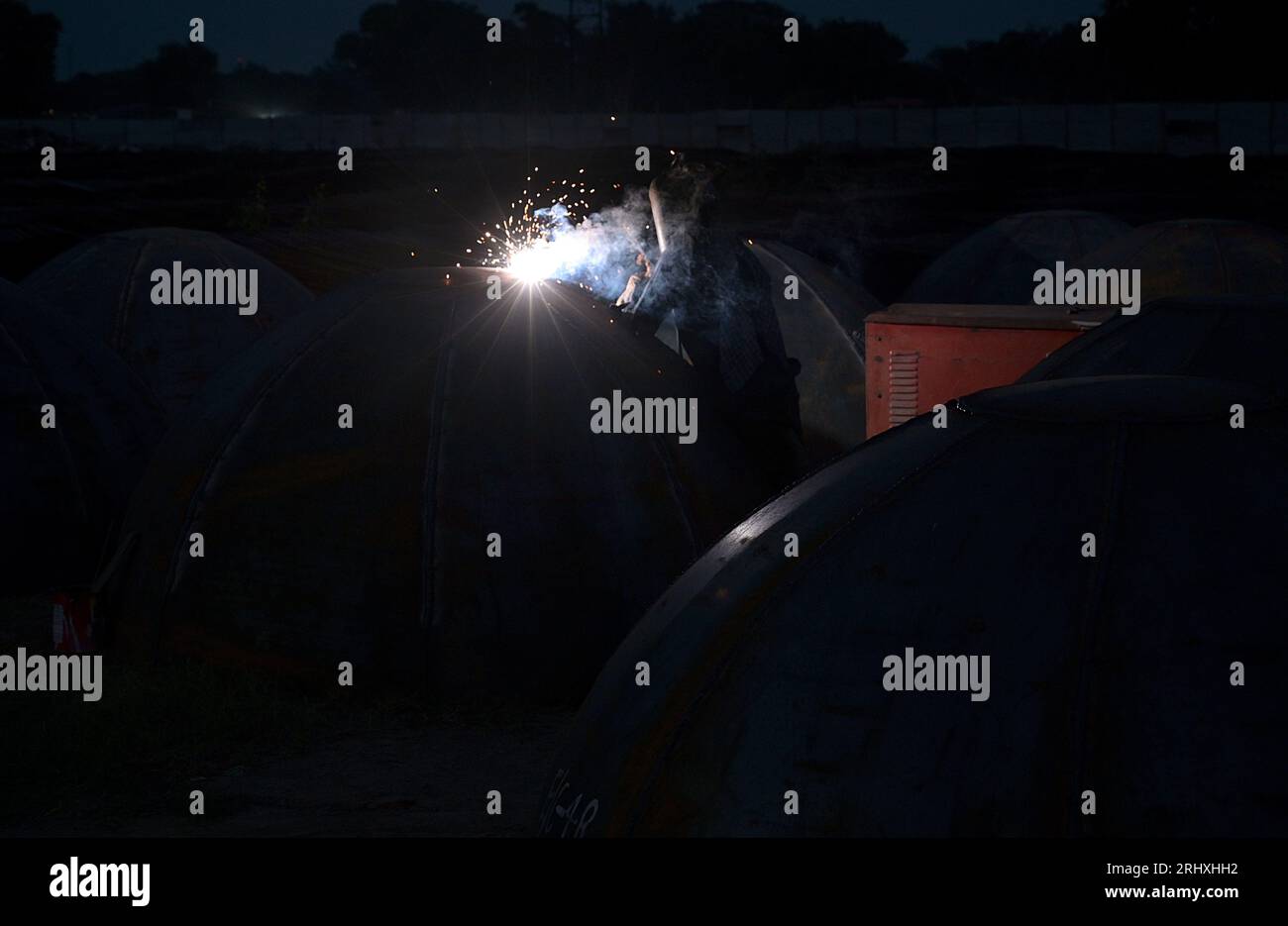 Prayagraj, India. 19th August 2023, A welder constructs a pontoon of ...