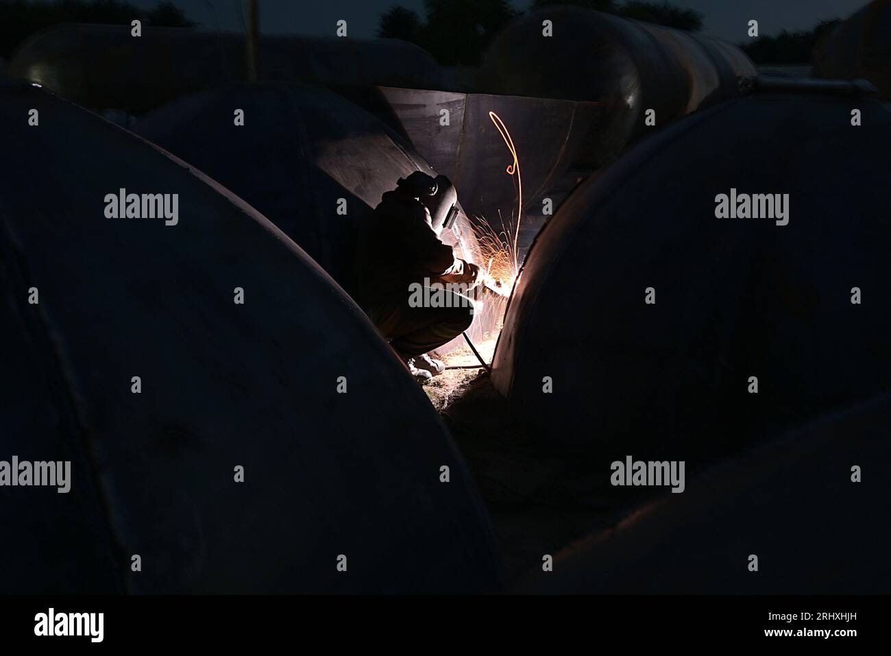 Prayagraj, India. 19th August 2023, A welder constructs a pontoon of ...
