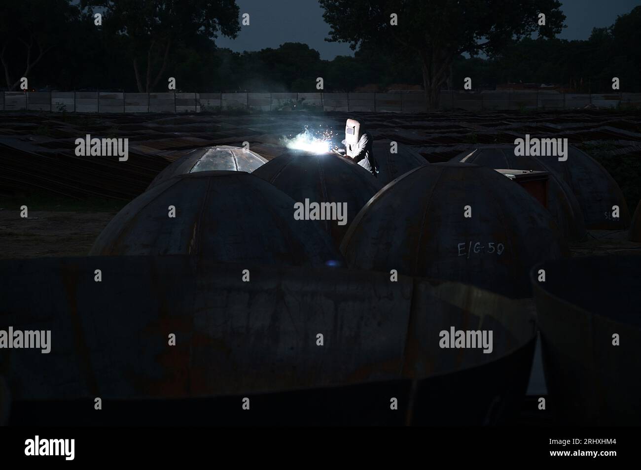 Prayagraj, India. 19th August 2023, A welder constructs a pontoon of ...