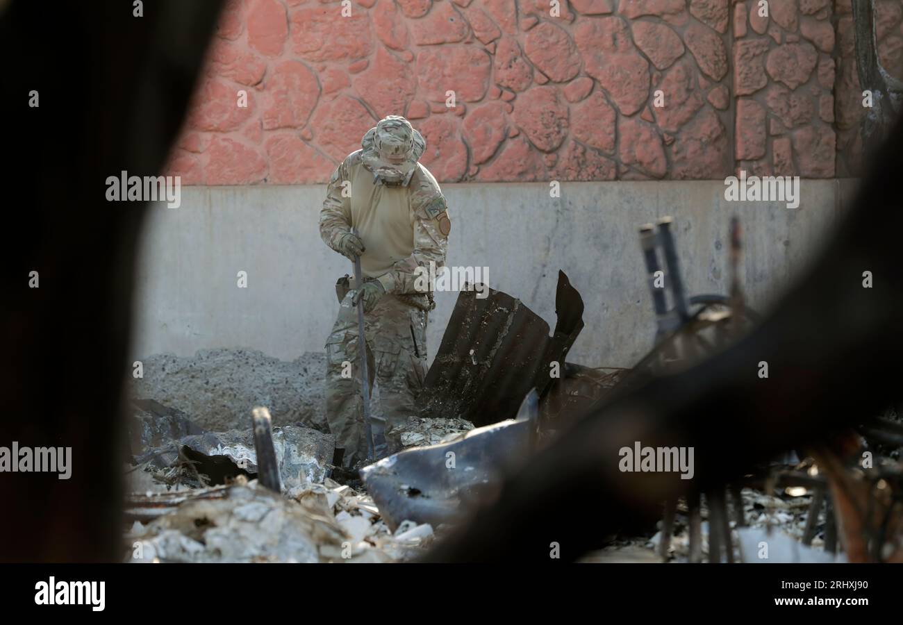 U.S. Border Patrol agents comb through a neighborhood destroyed by a ...