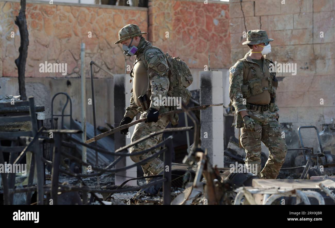 U.S. Border Patrol agents comb through a neighborhood destroyed by a ...