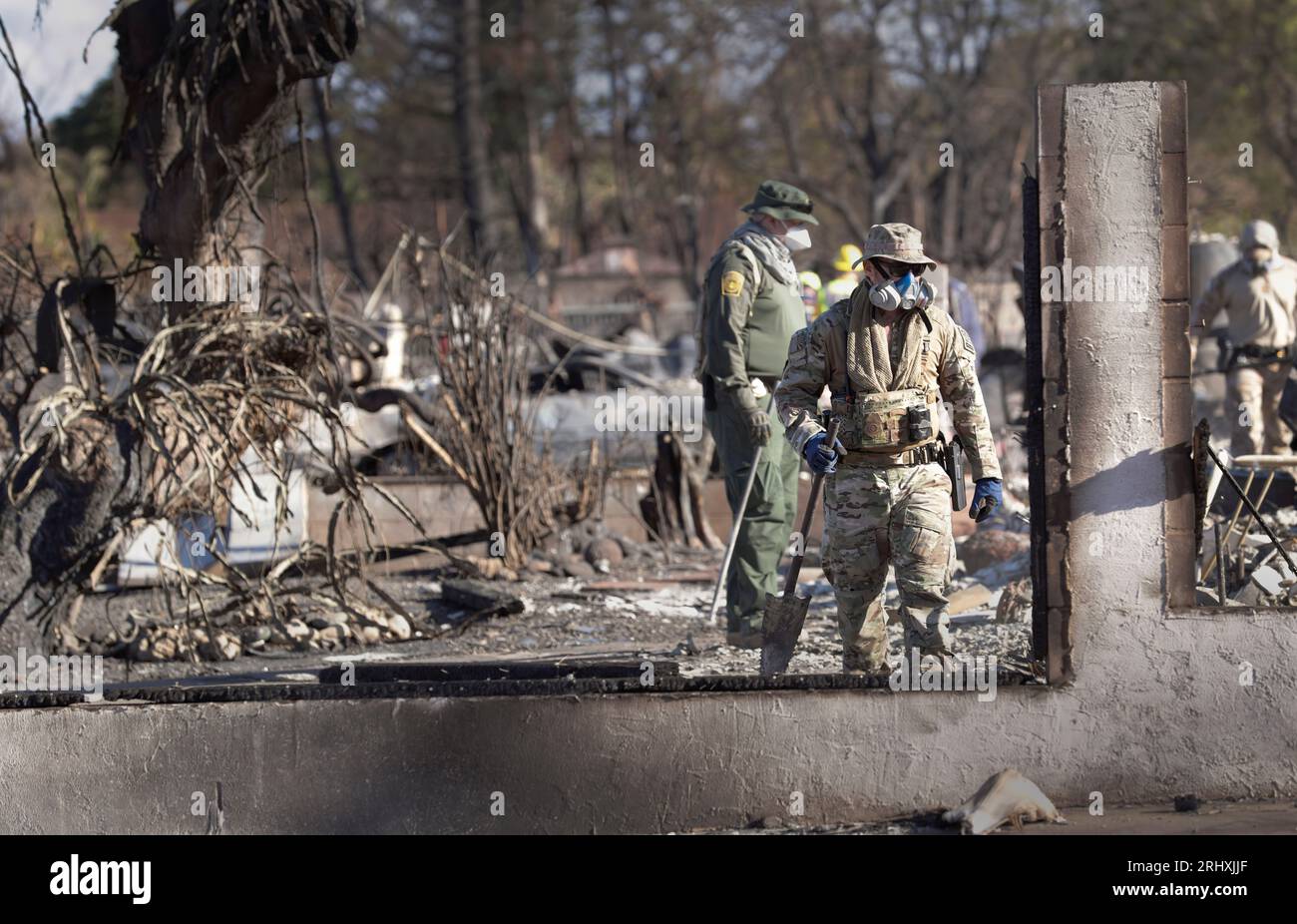 A U.S. Border Patrol agent combs through a neighborhood destroyed by a ...