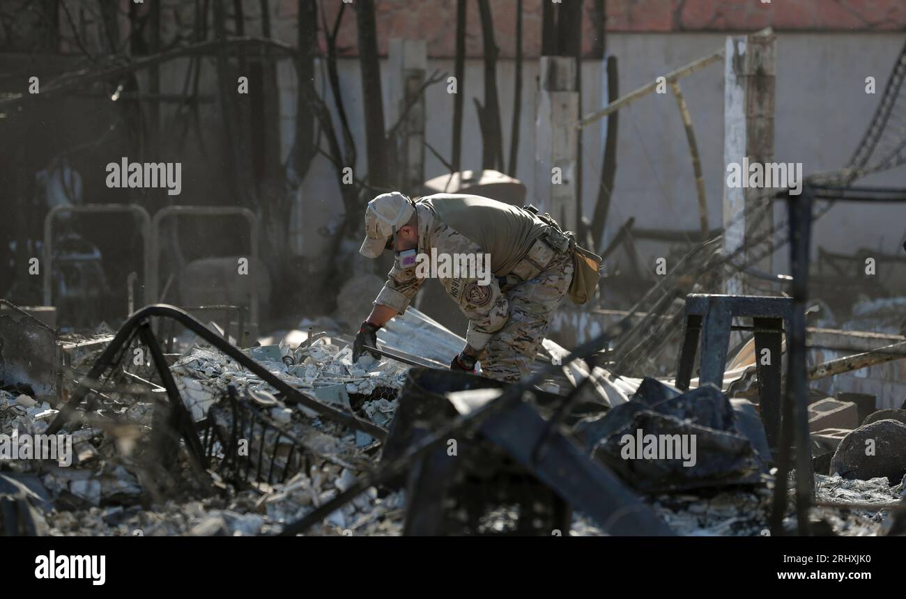 A U.S. Border Patrol agent combs through a neighborhood destroyed by a ...