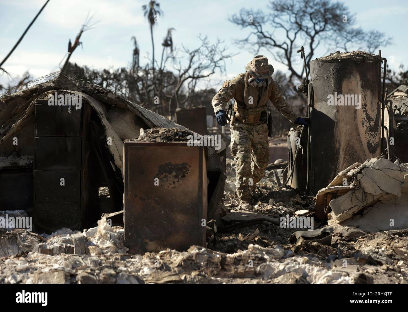 A U.S. Border Patrol agent combs through a neighborhood destroyed by a ...