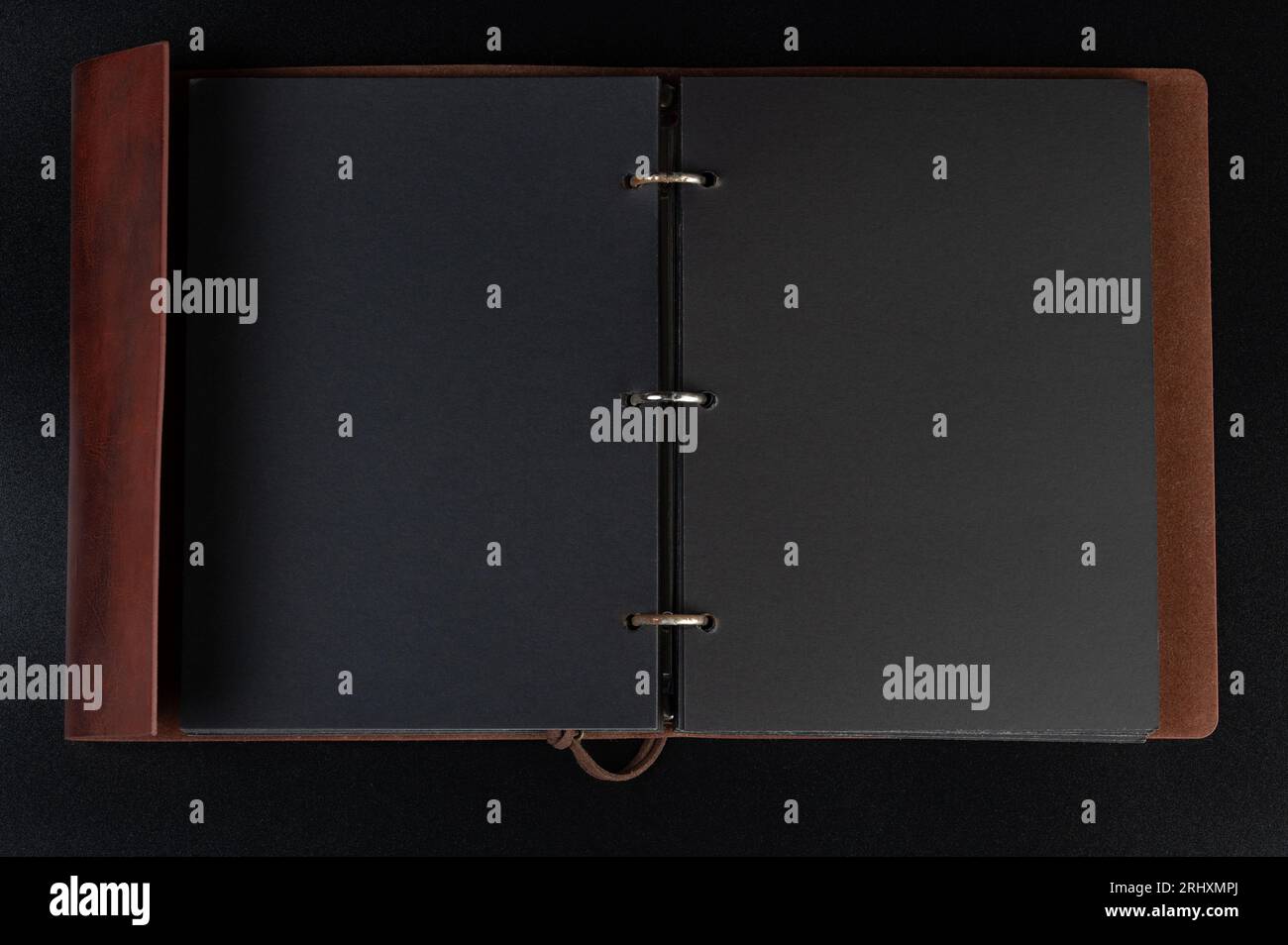Open binder with black pages in brown leather cover Stock Photo - Alamy