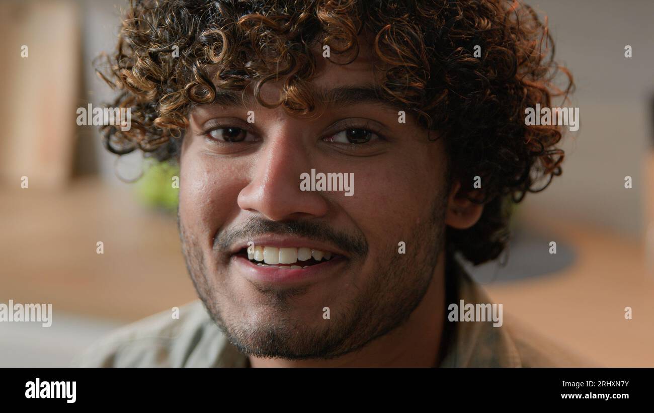 Close up smiling Arabian man homeowner with curly hair vlogger look at ...