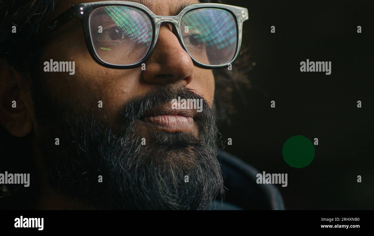 Thoughtful serious Indian businessman in eyeglasses looking away lost ...