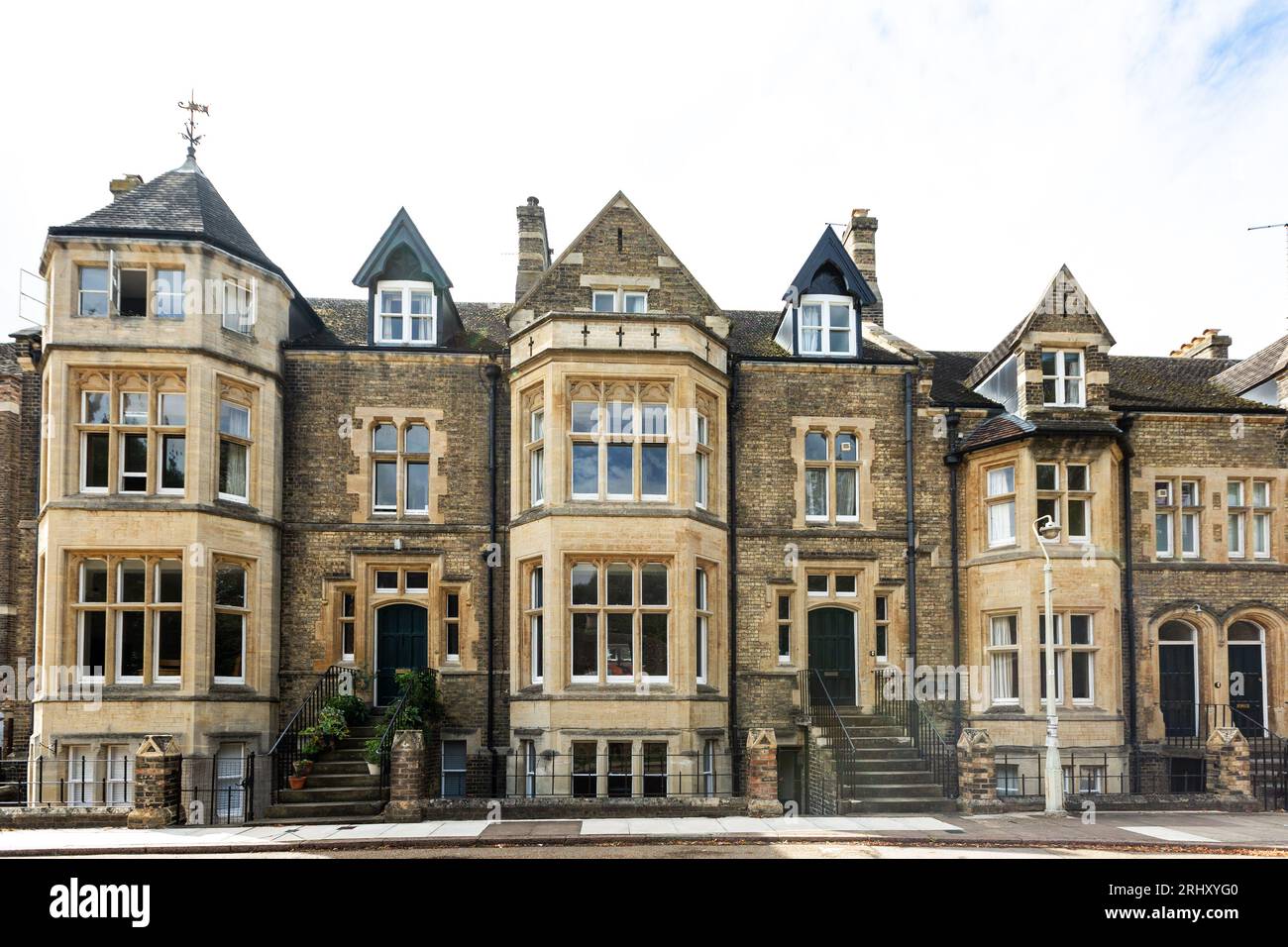 Landscape view of a row of traditional Victorian townhouses with four ...