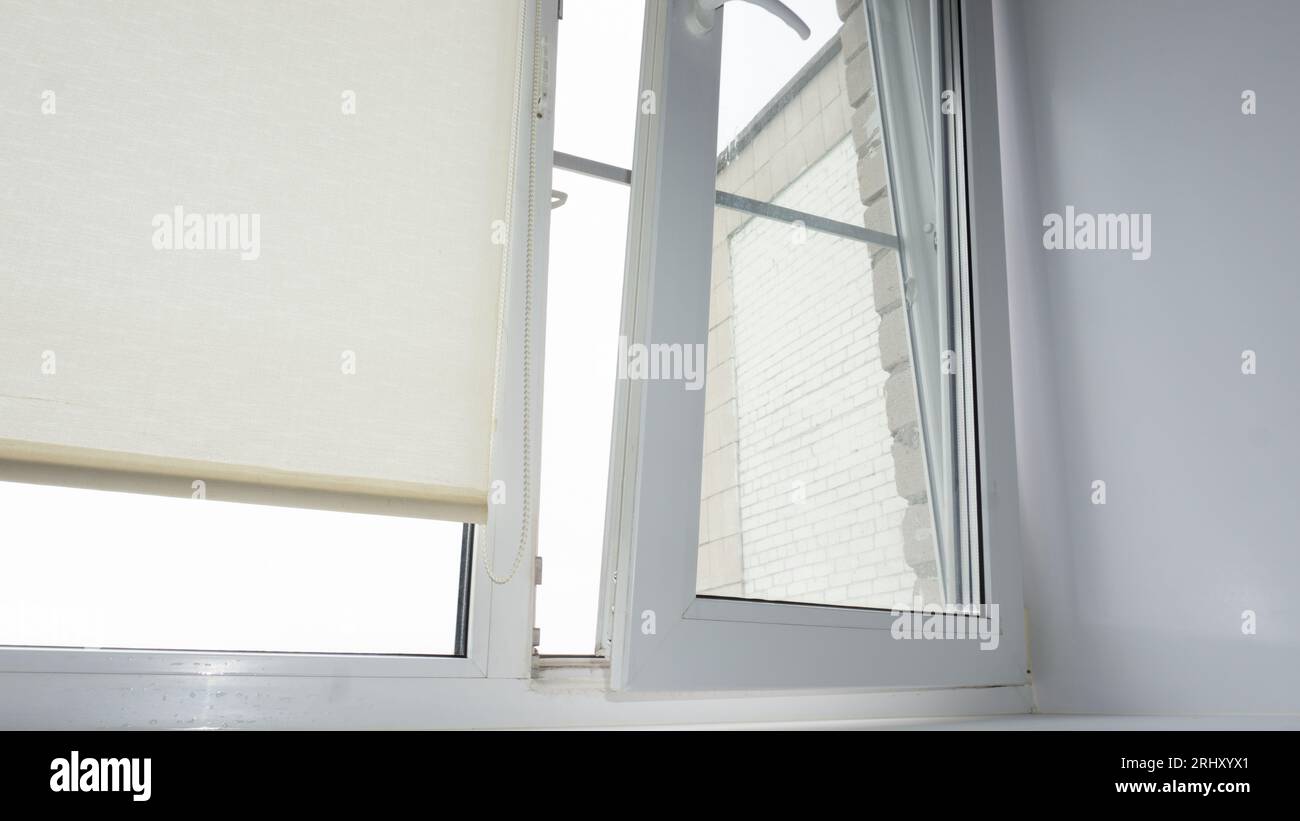 The double-glazed window is white with roller blinds. The window is not ...