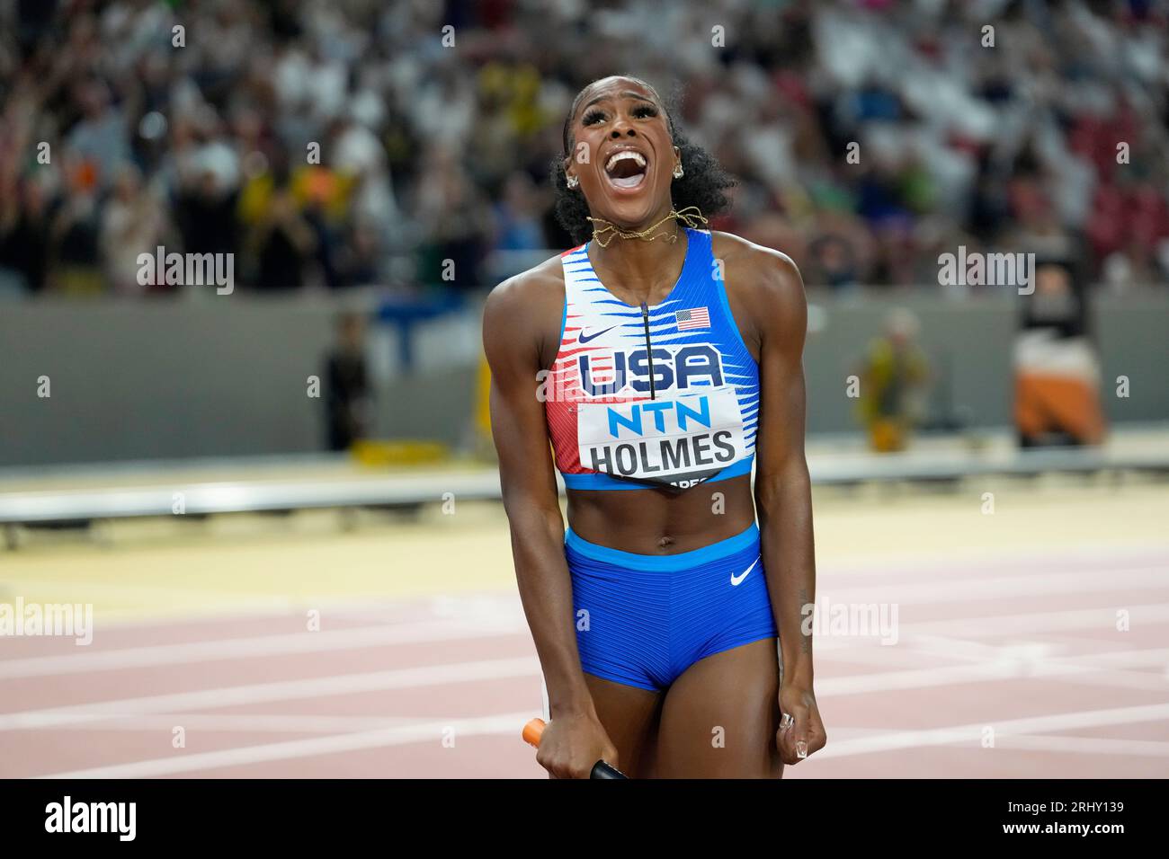 Alexis Holmes, of the United States, reacts after crossing the finish ...