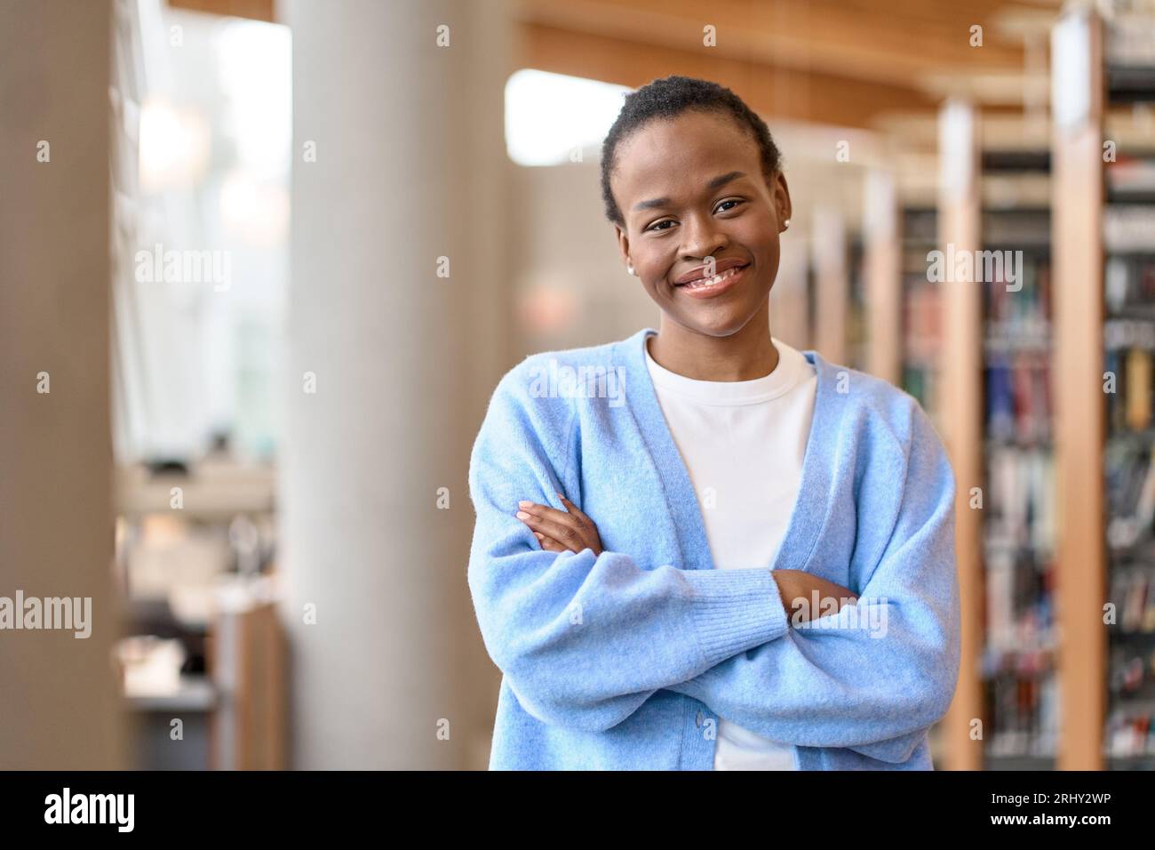 Happy Black African girl student standing in university library ...