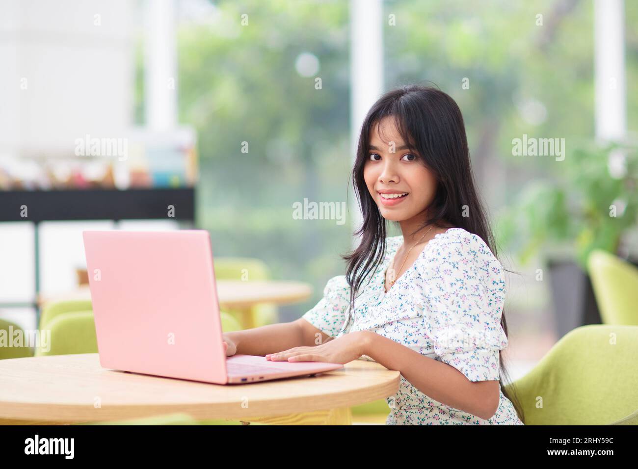 Beautiful teenager girl with laptop. Young female with long hair ...