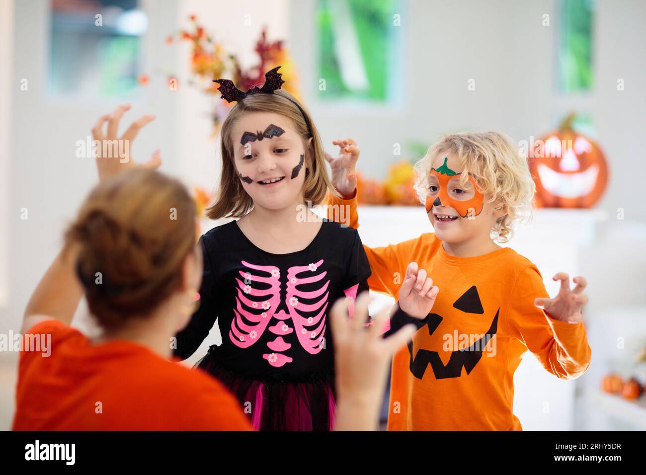 Child and mother in Halloween costume. Kids trick or treat. Face ...