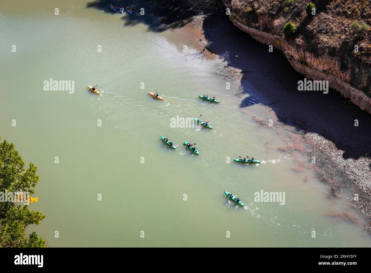 Colorful kayaks floating in green river under the cliff in the Parque ...