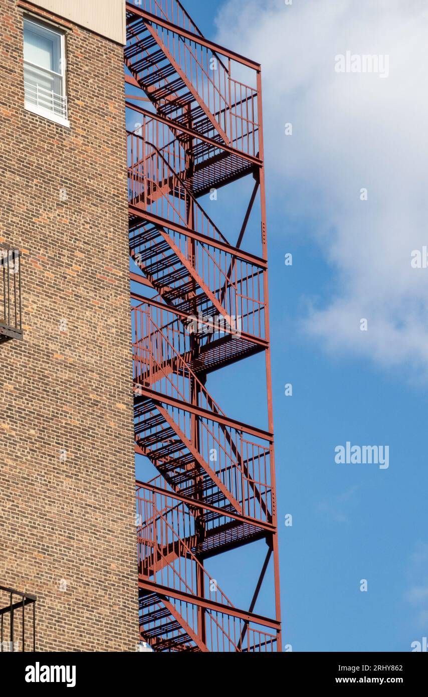 A sturdy, workable fire escape mounted on the backside of an apartment ...