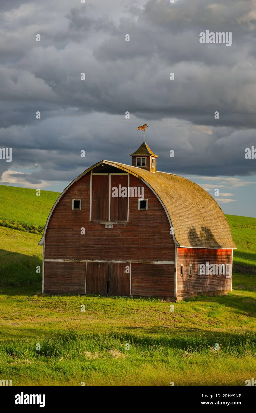 Old red barn (built 1918) and evening clouds at sunset. Latah County ...