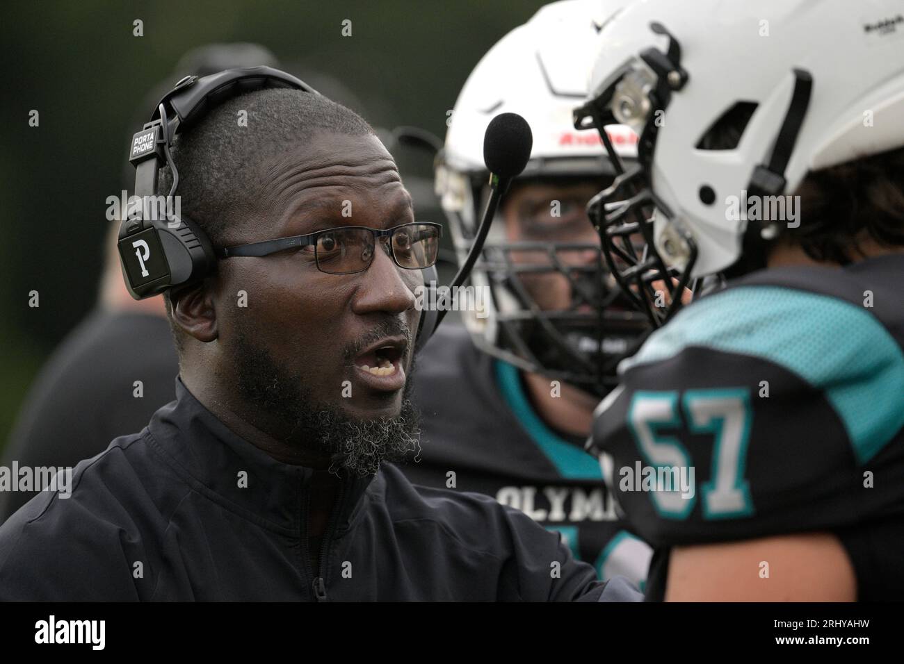 Olympia head coach Travis Gabriel talks to offensive lineman Jacob ...