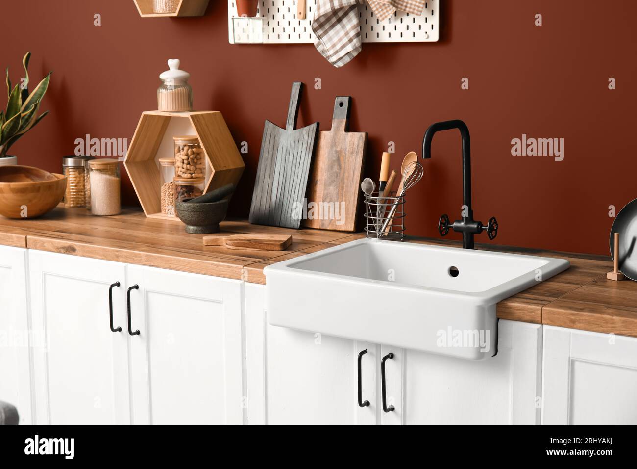 Wooden counters with sink and utensils in modern kitchen Stock Photo ...