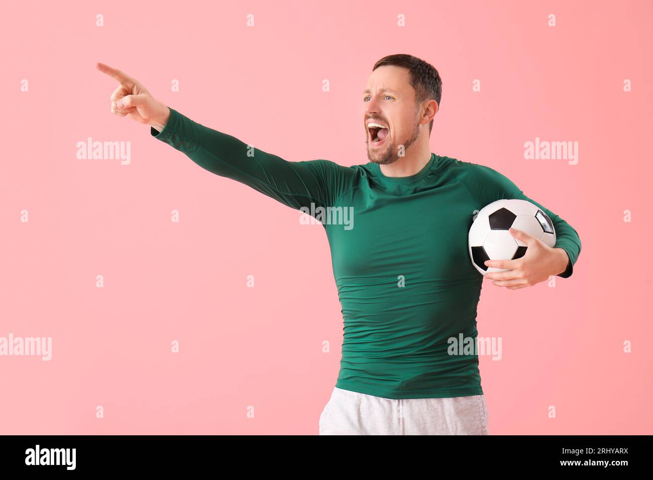 Screaming man with soccer ball on pink background Stock Photo - Alamy