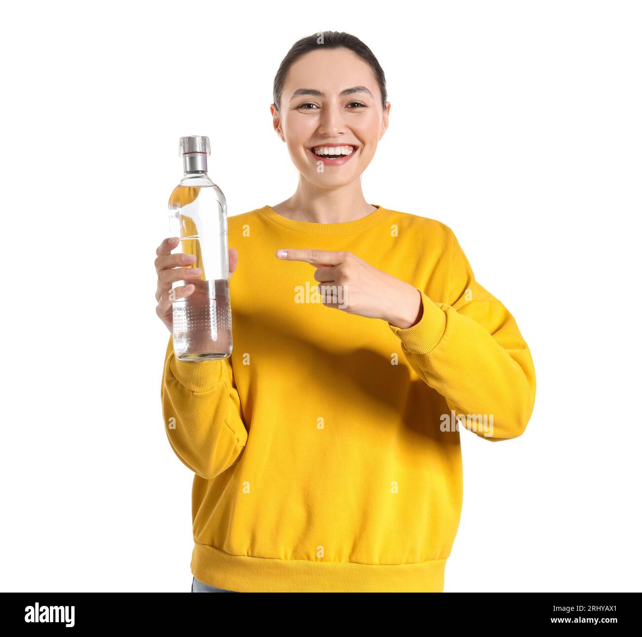 Young woman pointing at bottle of vodka on white background Stock Photo ...