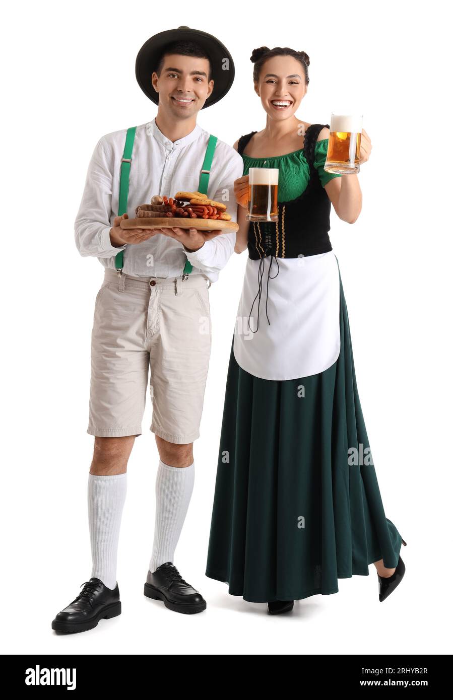 Young couple in traditional German clothes with beer and snacks on ...