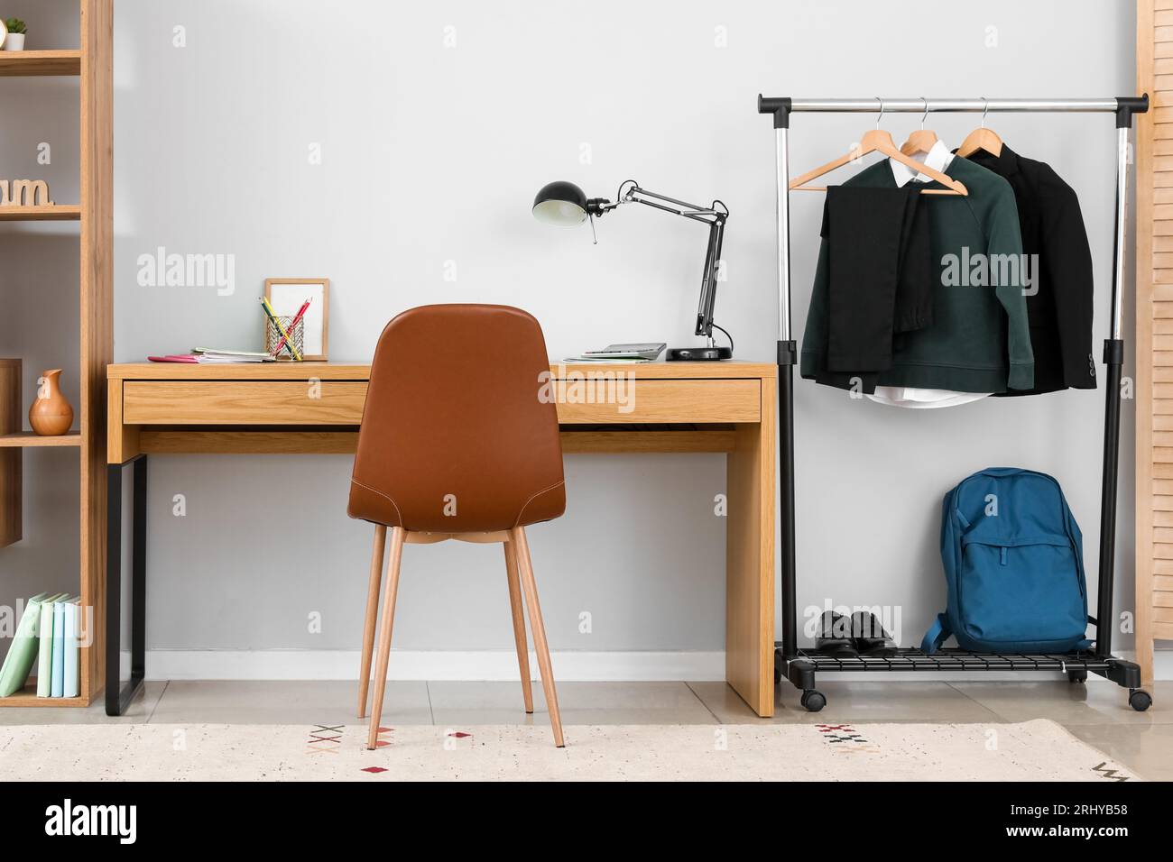 Interior of stylish room with modern workplace and school uniform on ...
