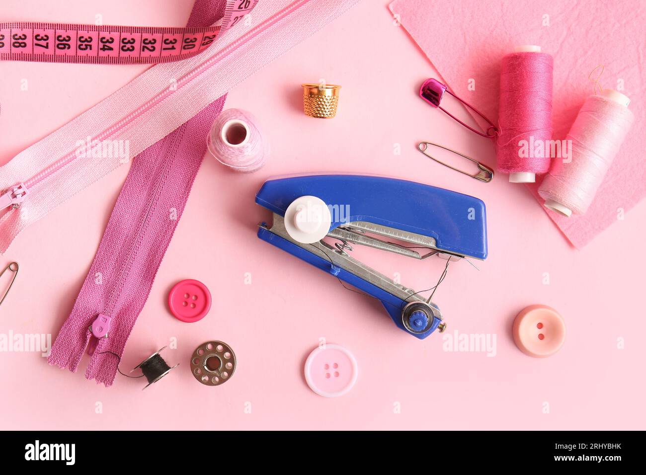 Manual sewing machine with different supplies on pink background Stock ...