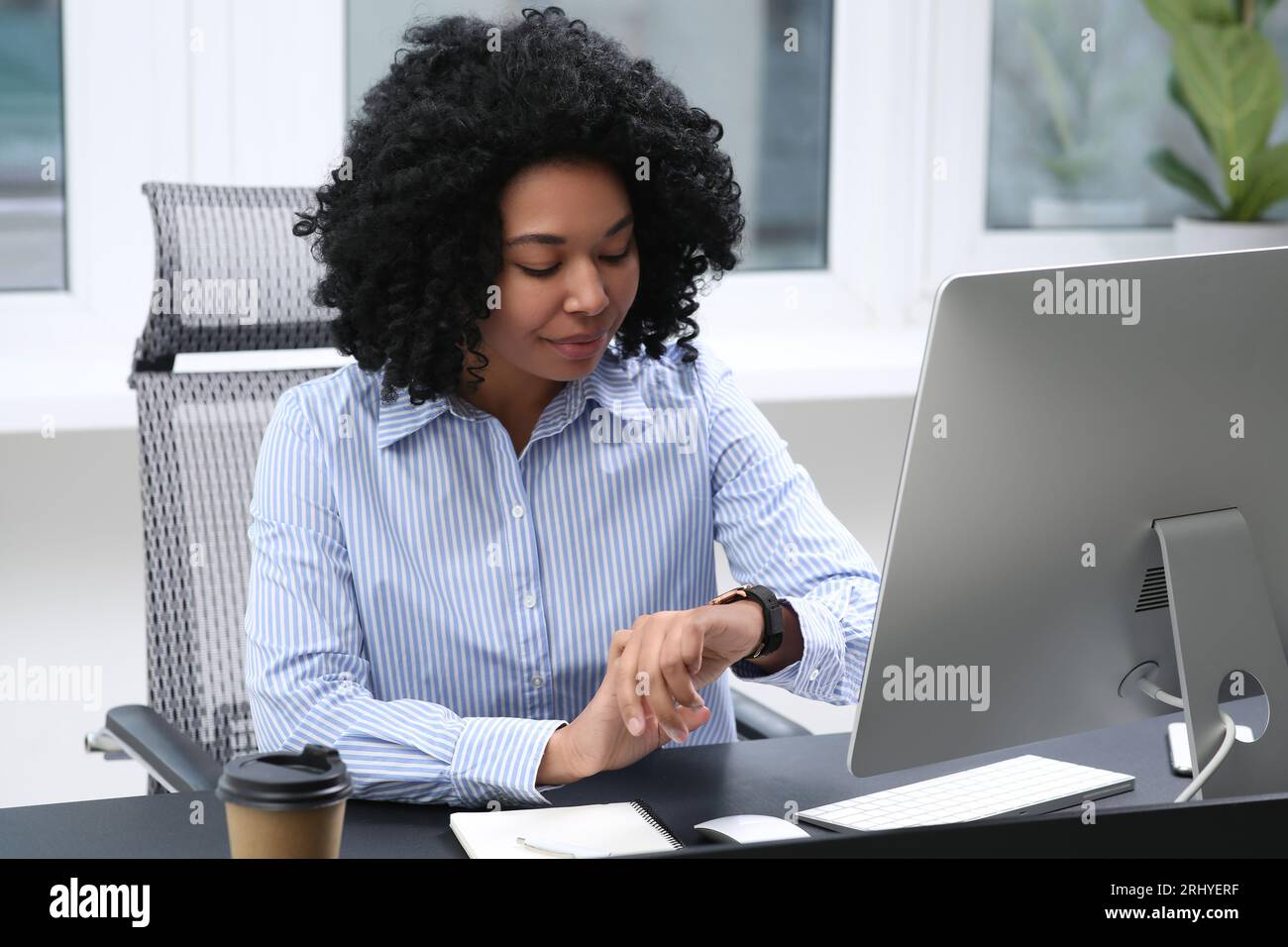 Busy woman checking watch and working hi-res stock photography and ...