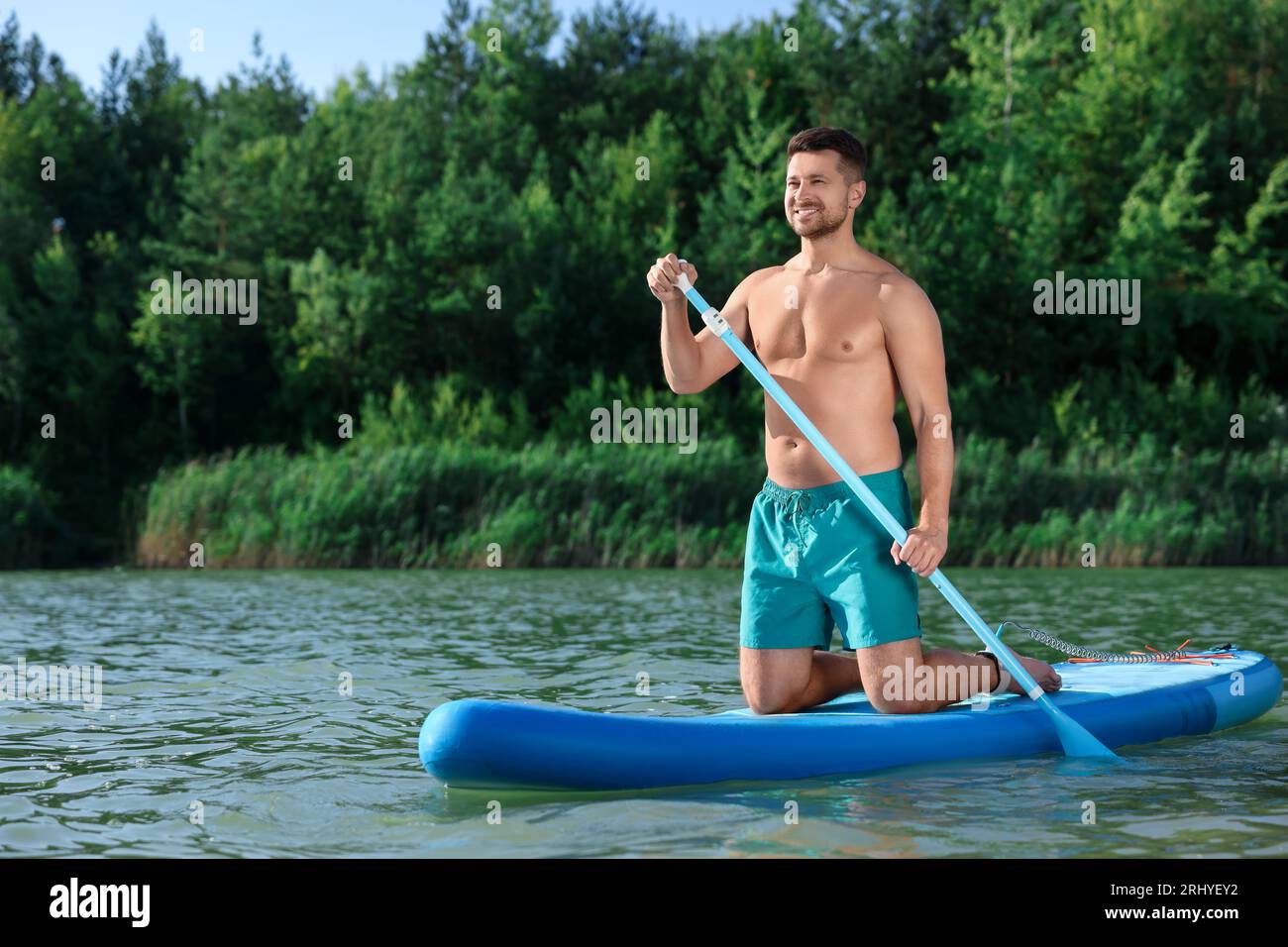 Man paddle boarding on SUP board in river Stock Photo - Alamy