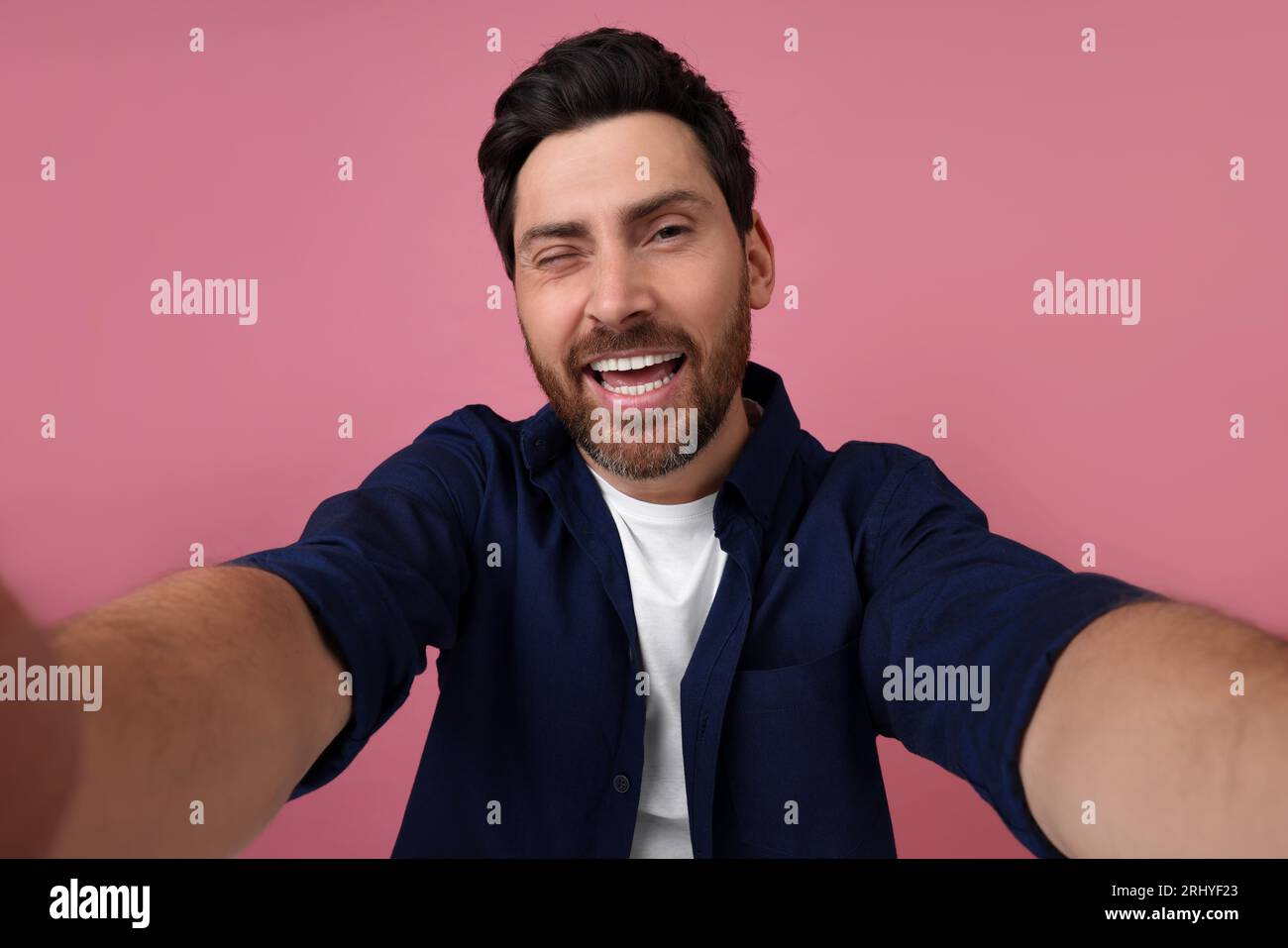 Cheerful handsome man winking hi-res stock photography and images - Alamy