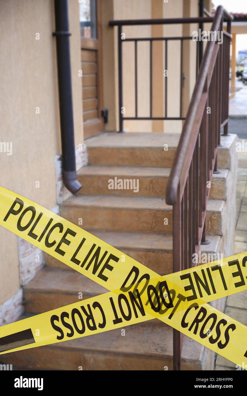 Yellow crime scene tape blocking way to stairs outdoors Stock Photo - Alamy