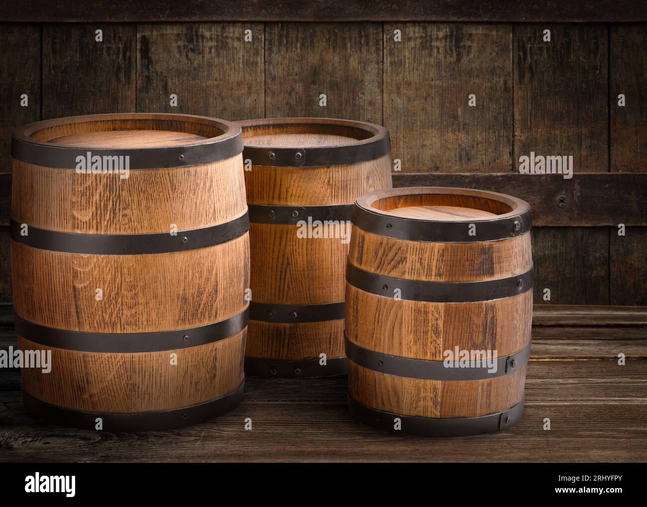 Three wooden barrels of different sizes in cellar Stock Photo - Alamy