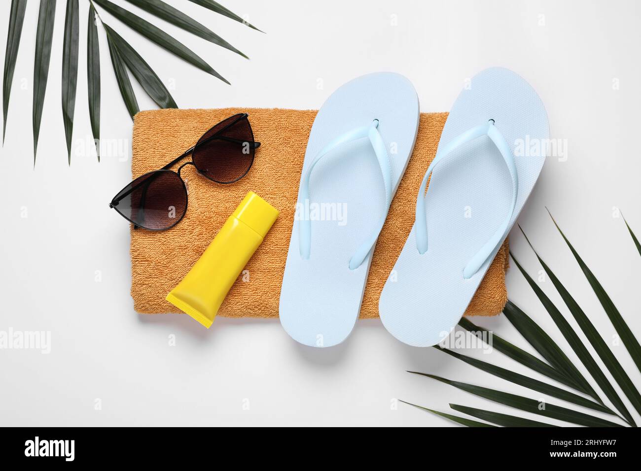Flat lay composition with sunscreen and beach accessories on white ...