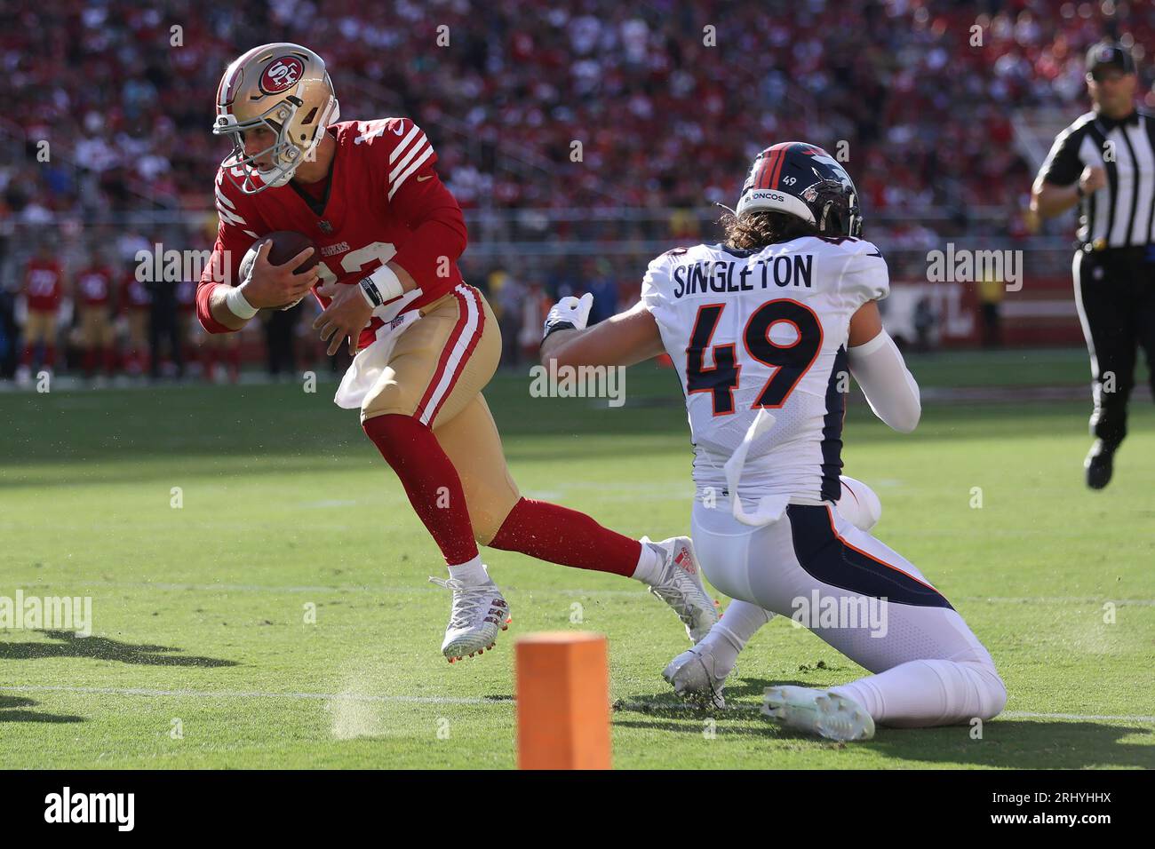 San Francisco 49ers quarterback Brock Purdy, left, runs against Denver ...