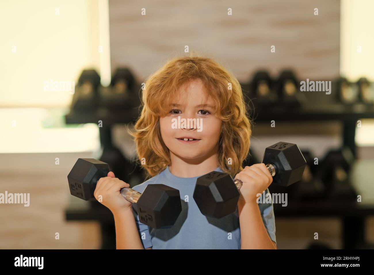 Child workout. Kid sport. Child exercising with dumbbells. Sporty child ...