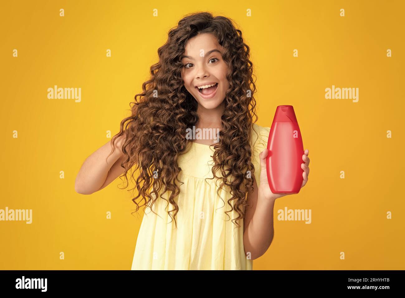 Happy portrait of child teen girl with shampoos conditioners and shower ...