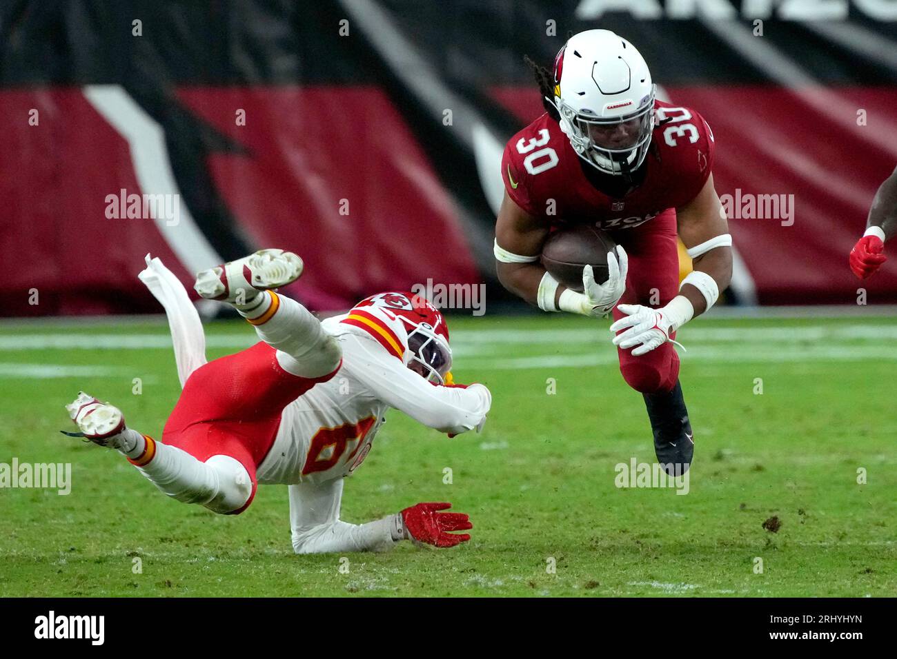 Arizona Cardinals running back Keaontay Ingram (30) is tripped up by ...