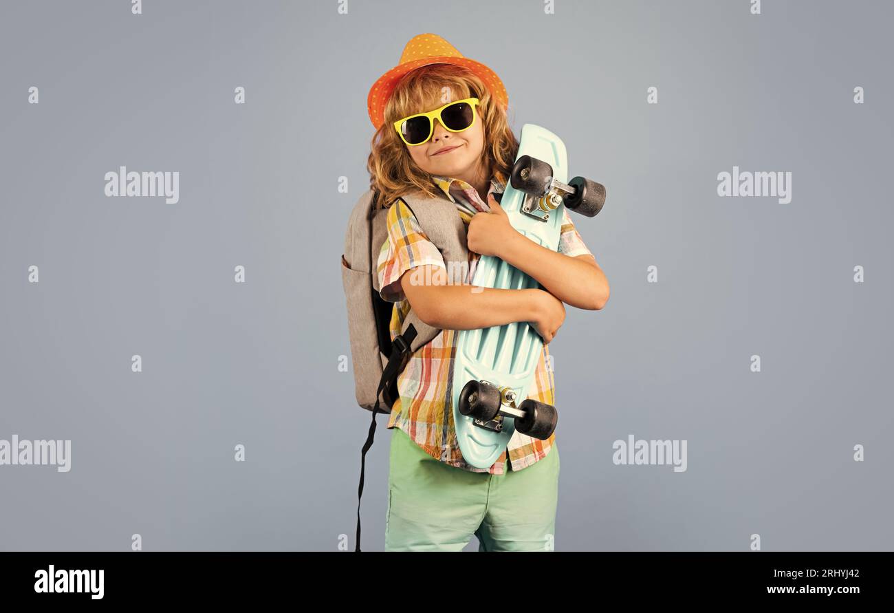 Studio portrait of stylish cute young child boy with skateboard ...