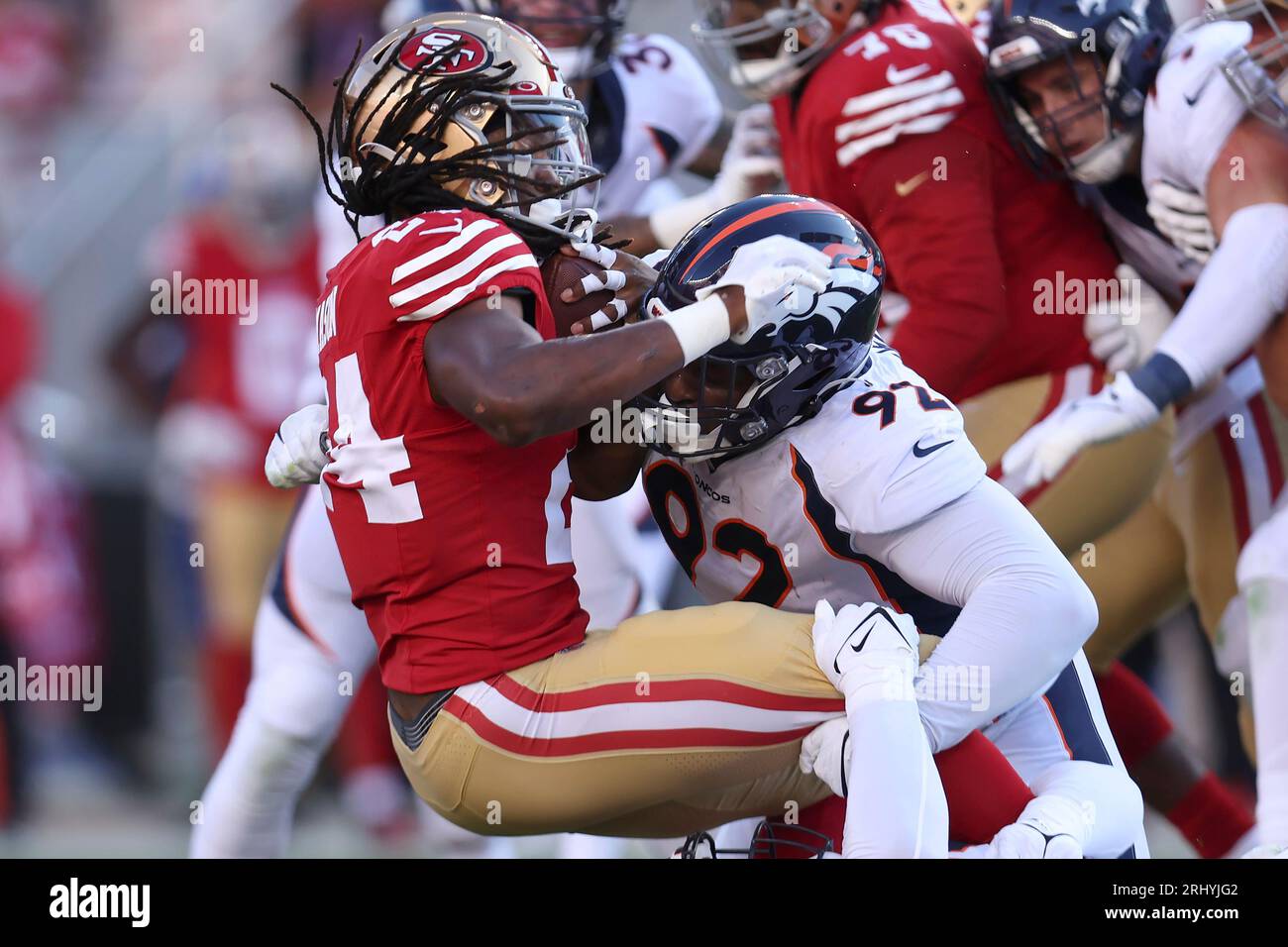 San Francisco 49ers running back Jordan Mason, left, is tackled by ...