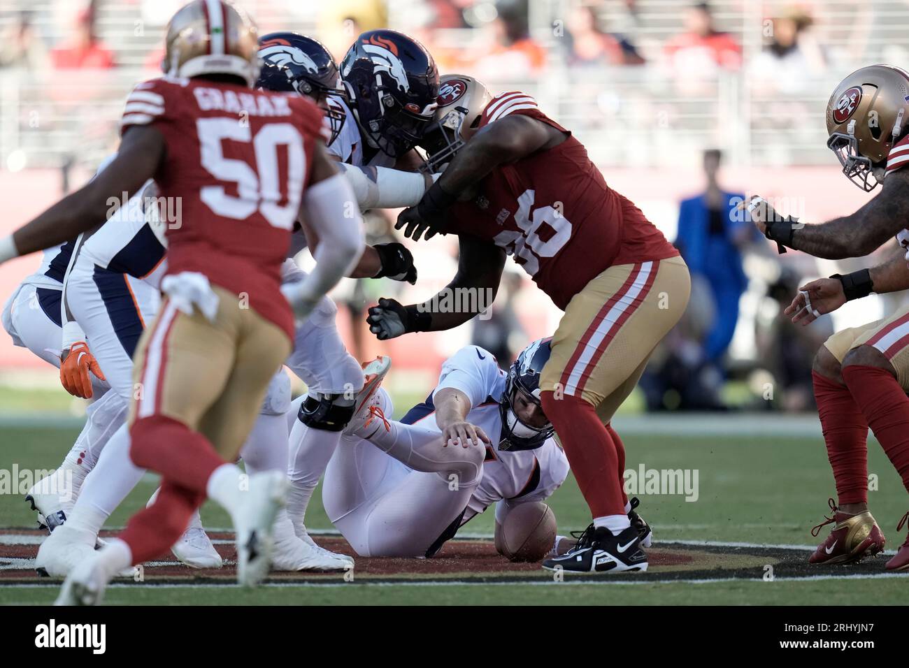 Denver Broncos quarterback Jarrett Stidham, bottom, recovers his own ...