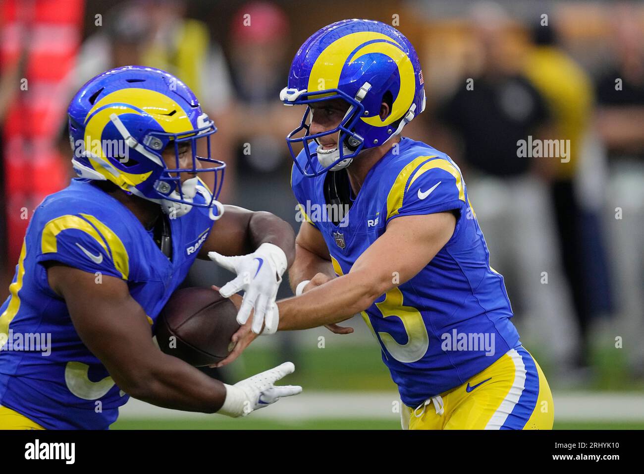 Los Angeles Rams quarterback Stetson Bennett, right, hands off to ...