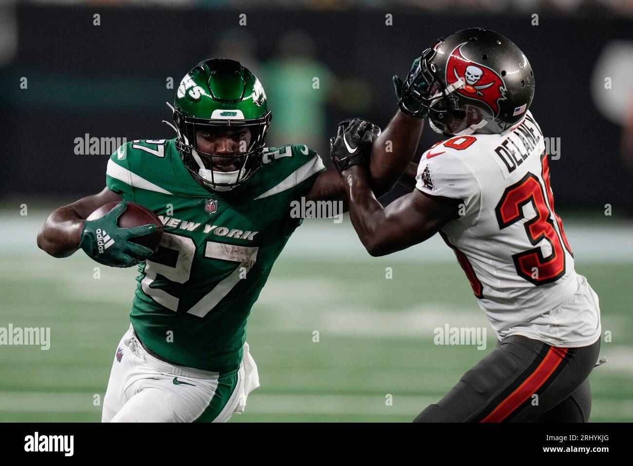 New York Jets running back Zonovan Knight (27) stiff-arms Tampa Bay ...